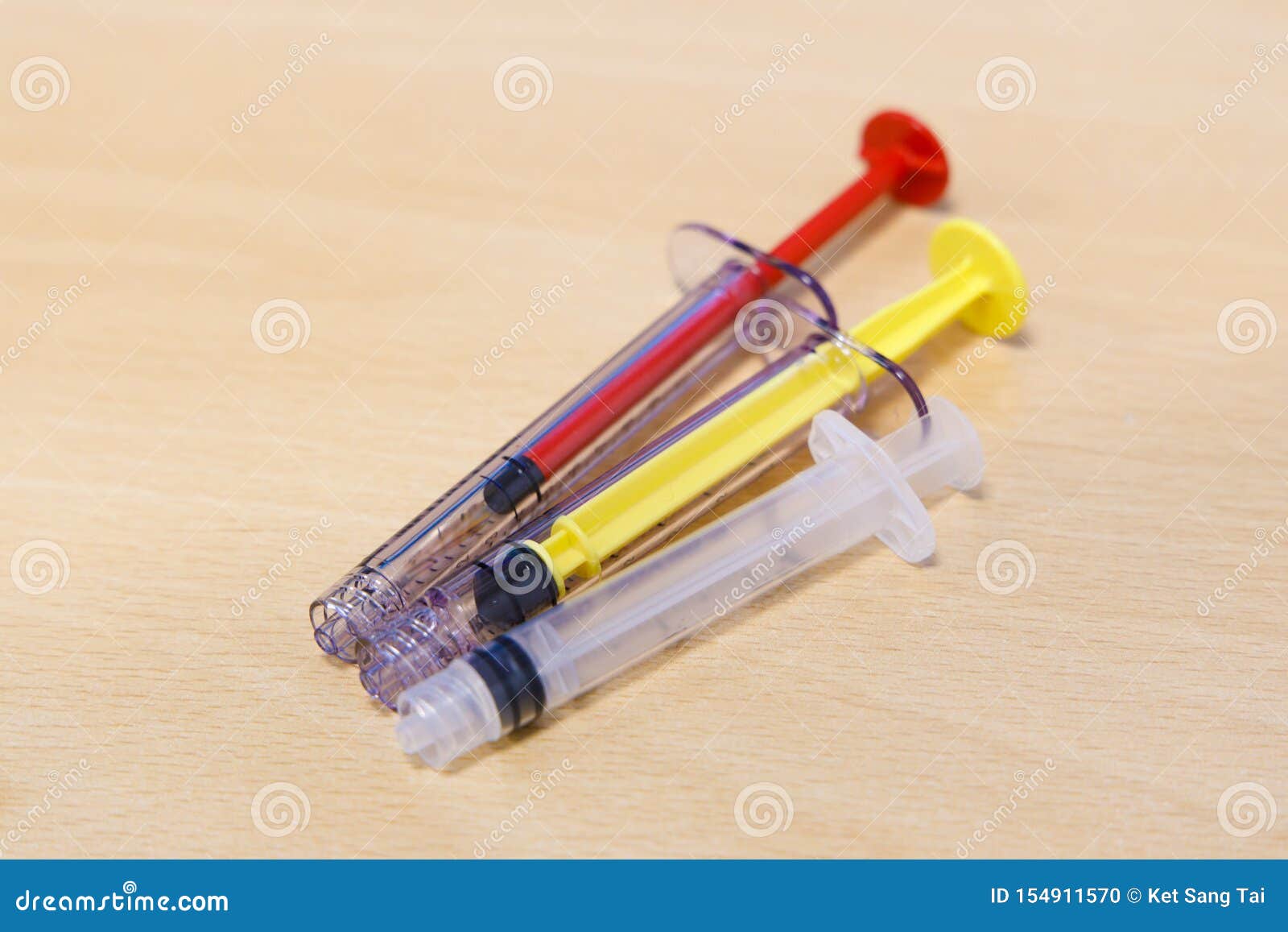 Three Medical Syringes of Different Colors and Size Stock Photo - Image ...