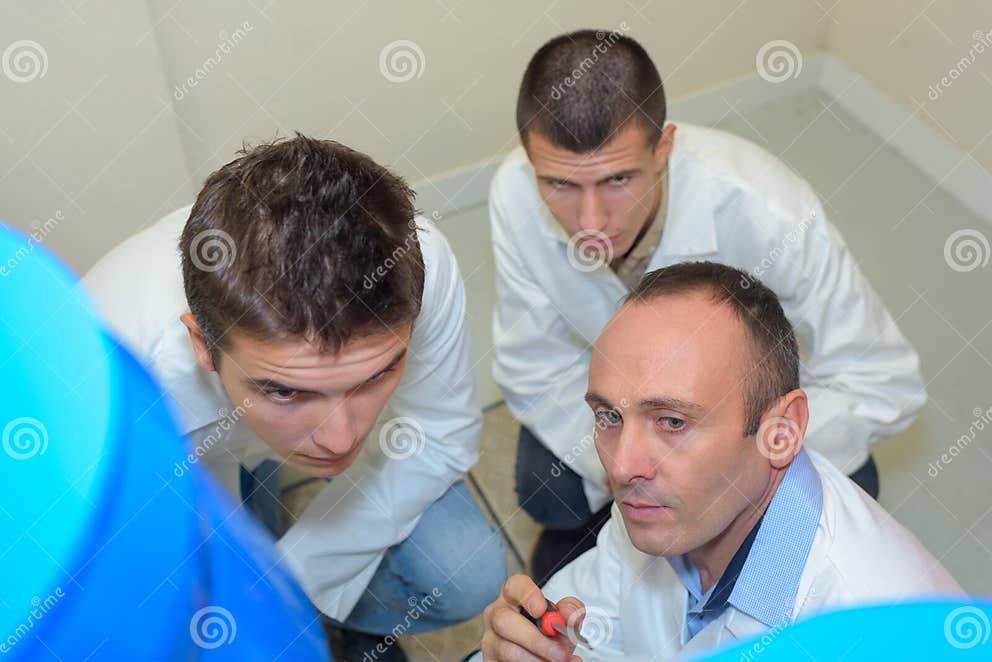 Three men doing inspection stock image. Image of label - 83011823