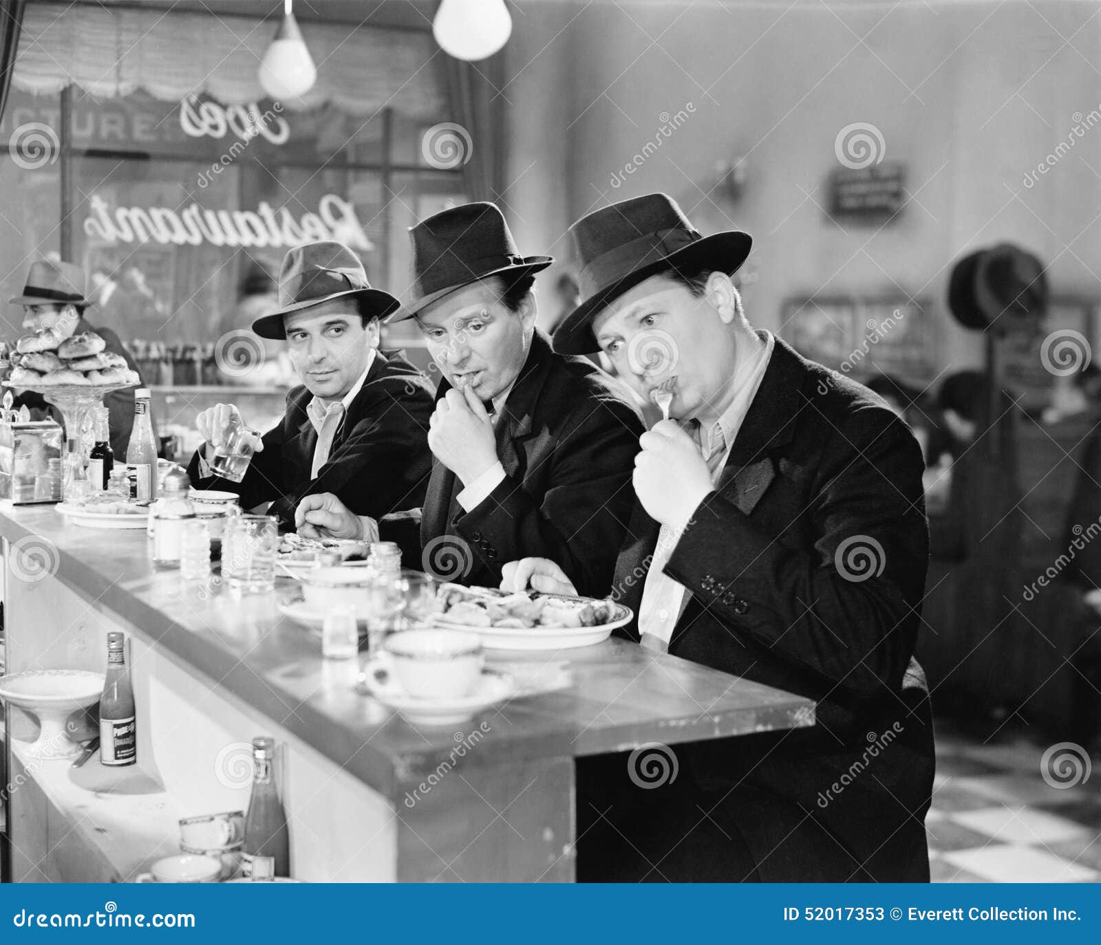 Three Men with Hats Eating at the Counter of a Diner Stock Image ...