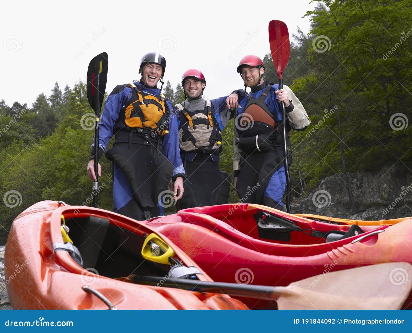 Three Men with Kayaks by River Portrait Stock Photo - Image of three ...