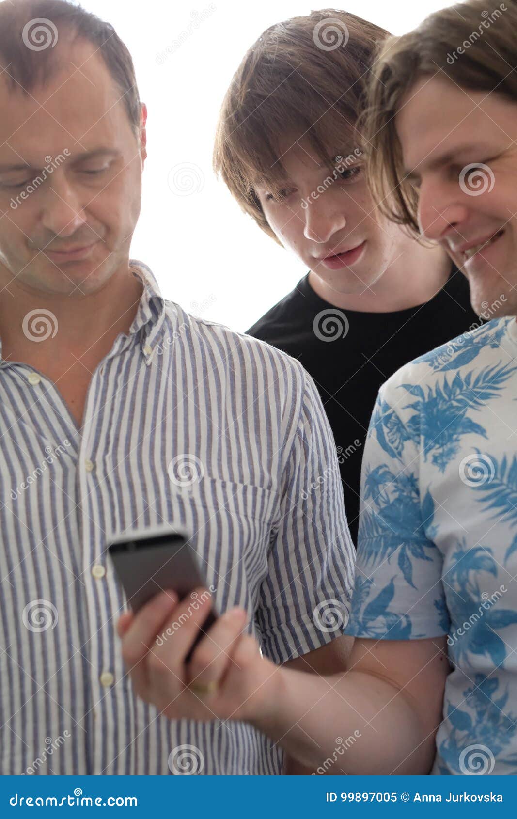 Three Men with a Mobile Phone Stock Image - Image of gadget, fingers ...