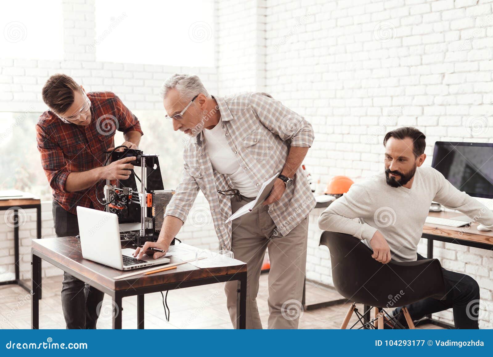Three Men Set Up a Self-made 3d Printer To Print the Form. they Check ...