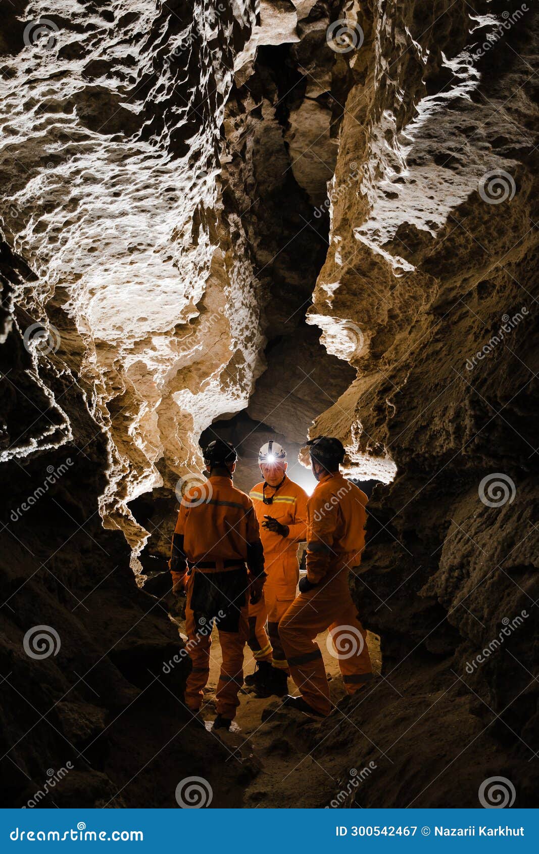 Three Men, Strong Physique, Explore the Cave. Men Dressed in Special ...