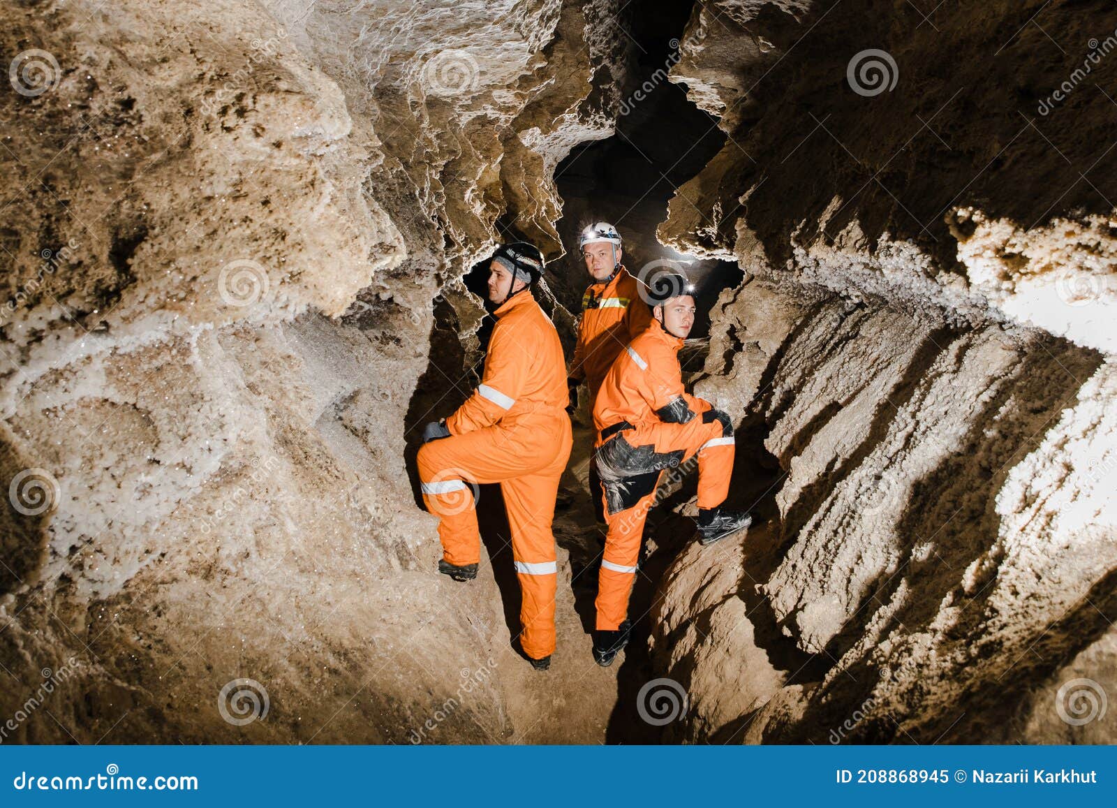 Three Men, Strong Physique, Explore the Cave. Men Dressed in Special ...