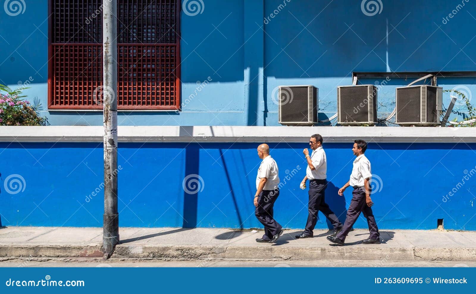 Three Men Walking on a Sidewalk Editorial Image - Image of blue, street ...