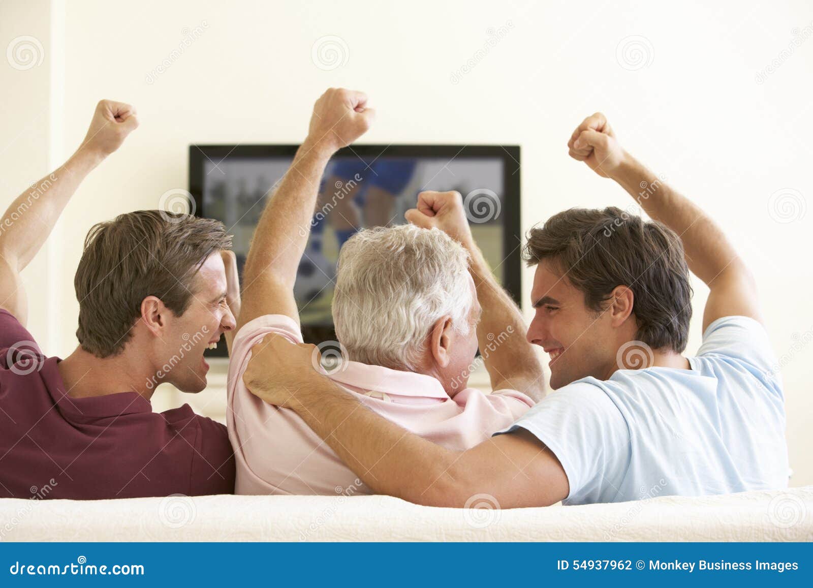 Three Men Watching Widescreen TV at Home Stock Photo - Image of ...