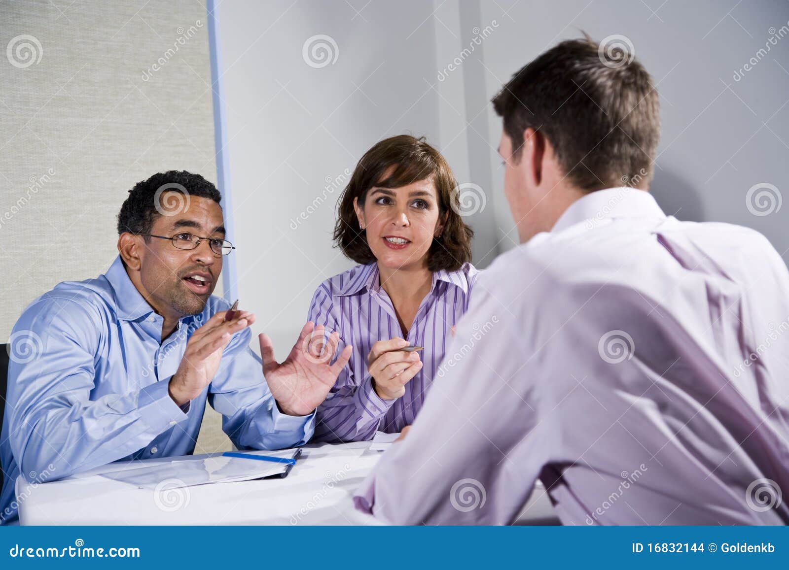 Three Mid-adult People Sitting at Table Meeting Stock Photo - Image of ...