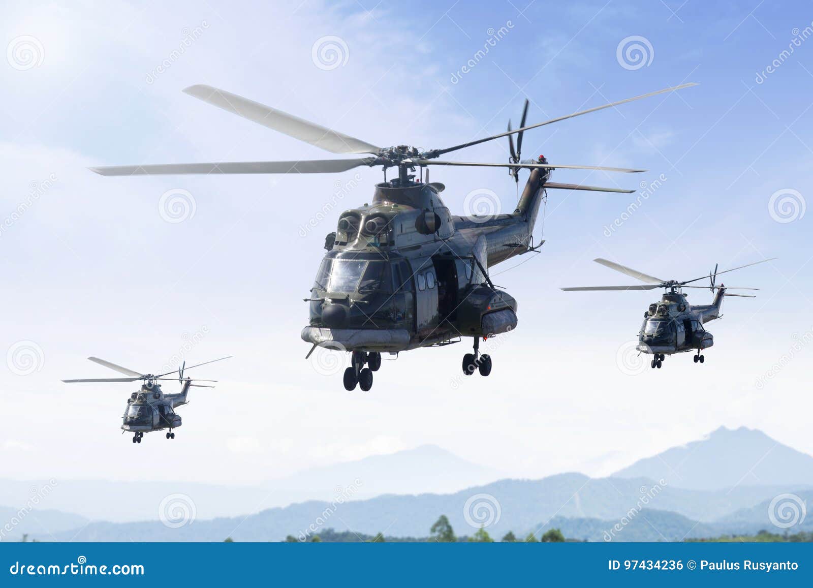 Three Military Helicopters Patrolling in the Mountain Stock Photo ...