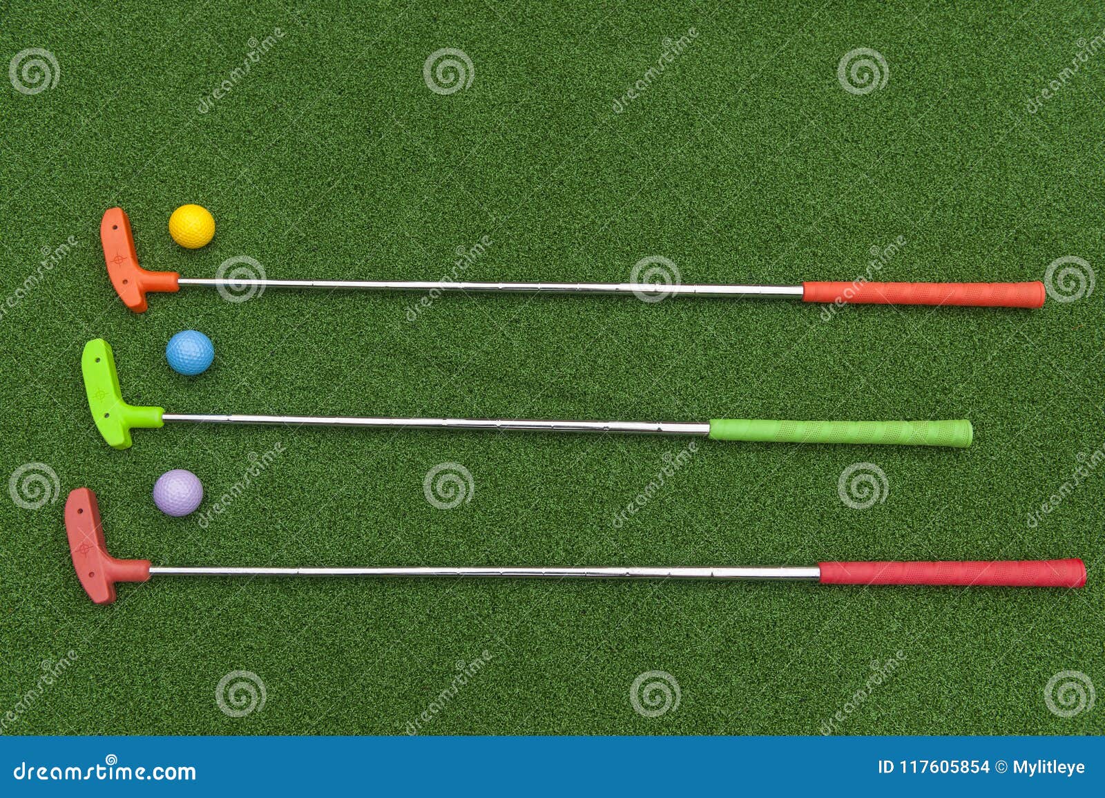 Three Mini Golf Putters with Balls Stock Photo - Image of colorful ...