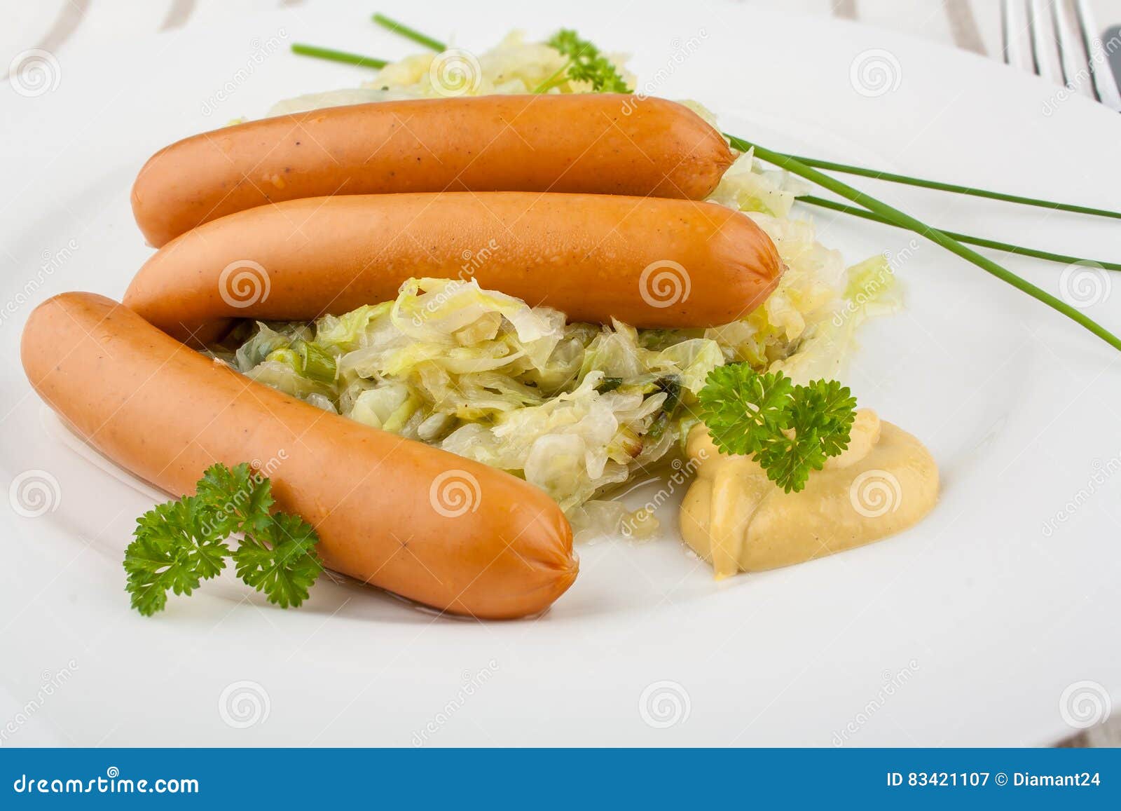 Three Mini Wieners on Fried Cabbage with Mustard Stock Image - Image of ...