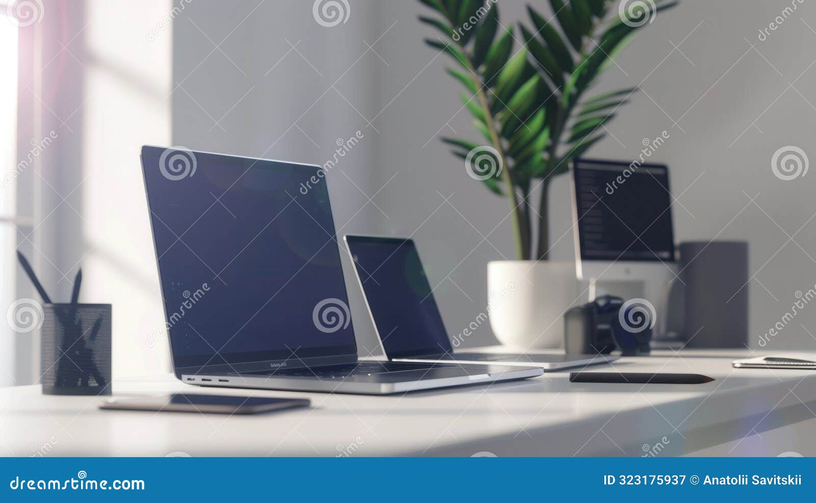 Three Modern Laptops and Tablets are Shown on a Sleek Desk, with ...