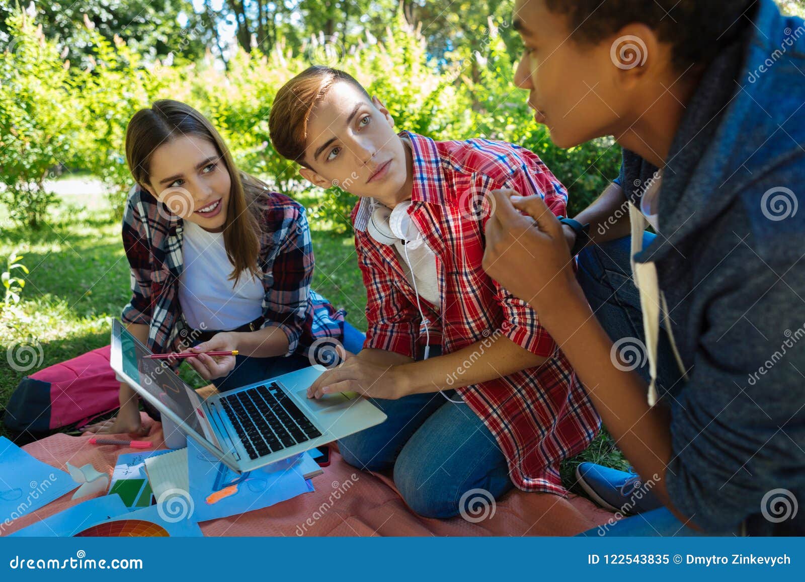 Three Modern Students Looking on the Screen of Laptop Stock Image ...