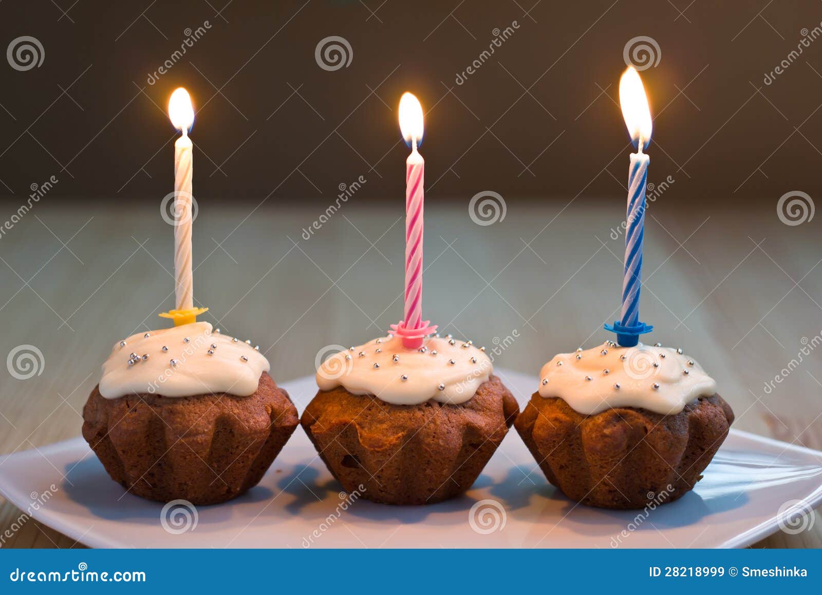 Three Muffins with Burning Candles Stock Image - Image of frosted ...