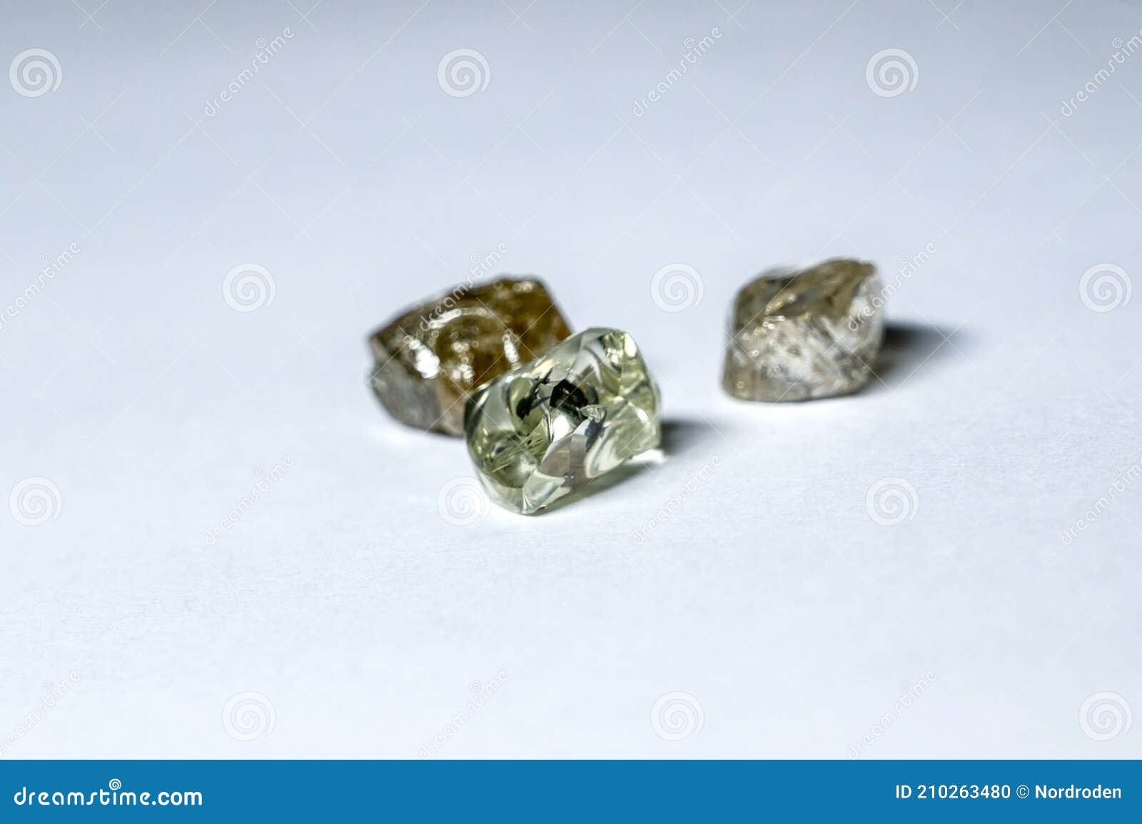 Three Multi-colored Diamonds Lie on a White Plastic Surface Stock Photo ...