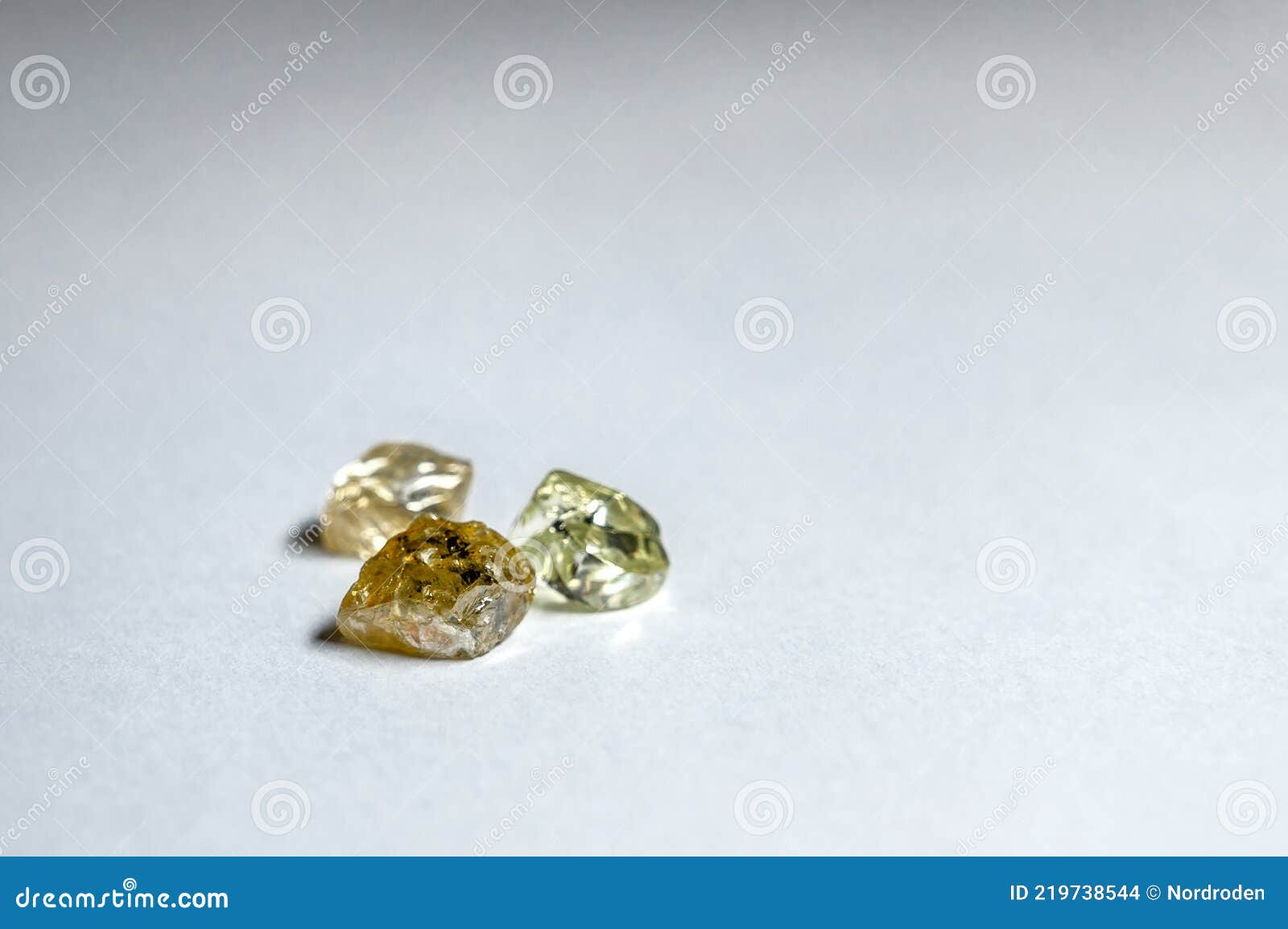 Three Multi-colored Diamonds Lie on a White Plastic Surface Stock Photo ...