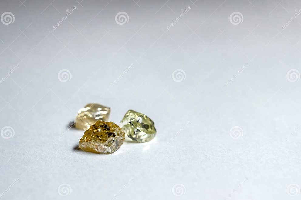 Three Multi-colored Diamonds Lie on a White Plastic Surface Stock Photo ...