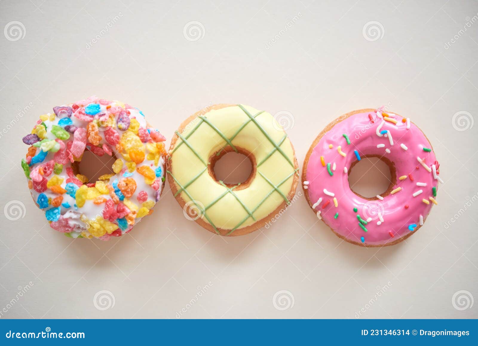 Three Multi-colored Doughnuts Isolated on White Background Stock Photo ...