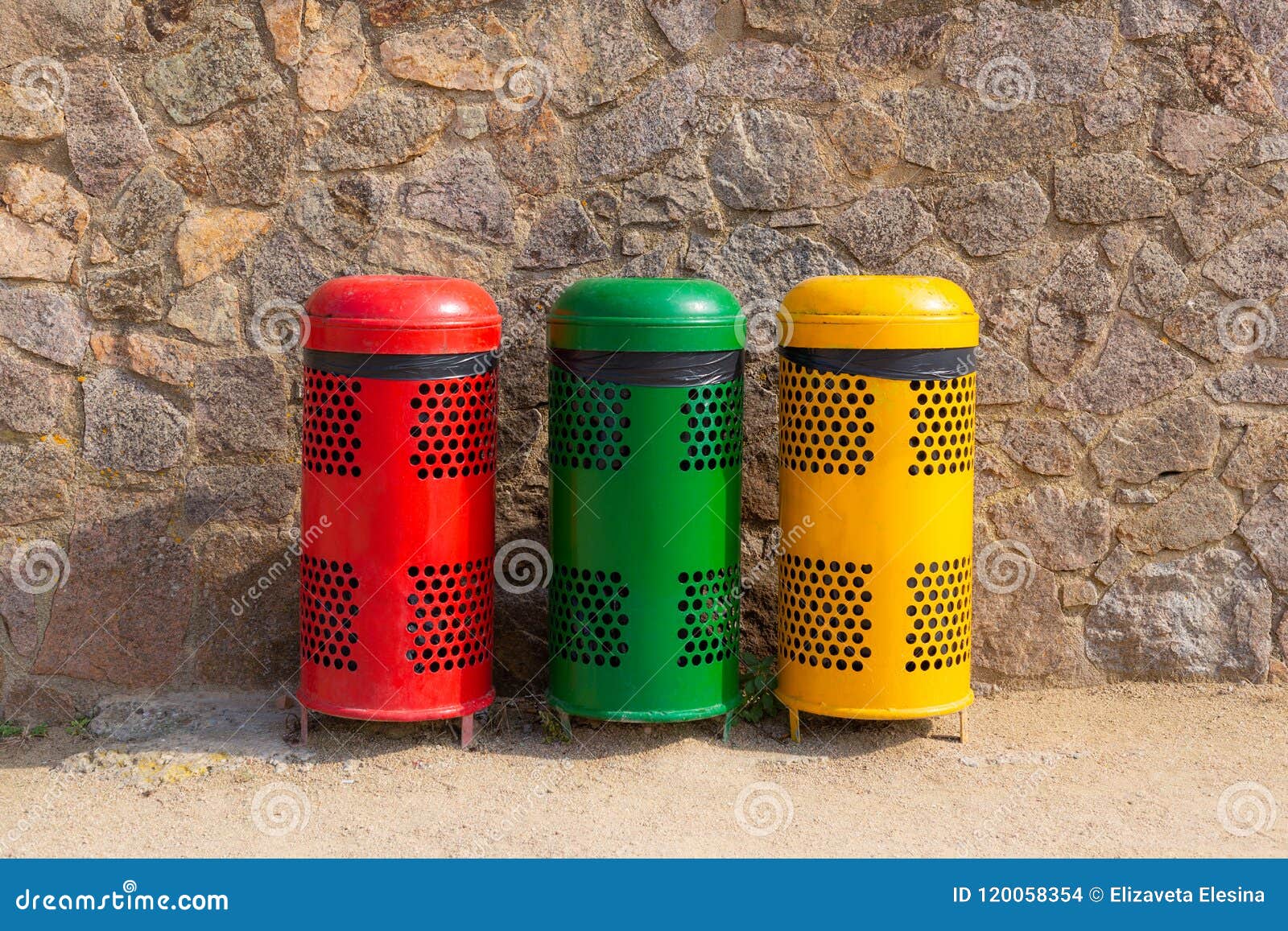 Three Multicolored Recycle Bins for Waste Near the Wall. Sort Waste ... Three Multicolored Recycle Bins for Waste Near the Wall. Sort Waste ...