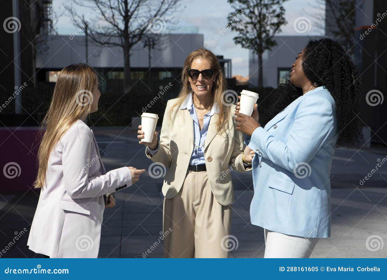 Three Multiethnic Women of Different Ages Stroll while Having a Coffee ...