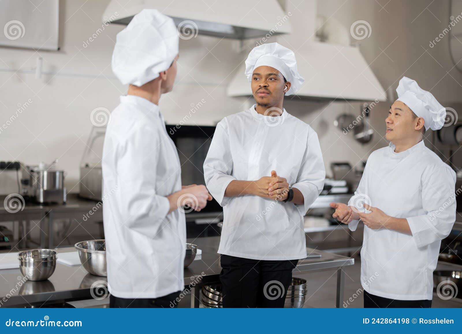 Three Multiracial Chef Cooks Talk while Standing Together during a ...
