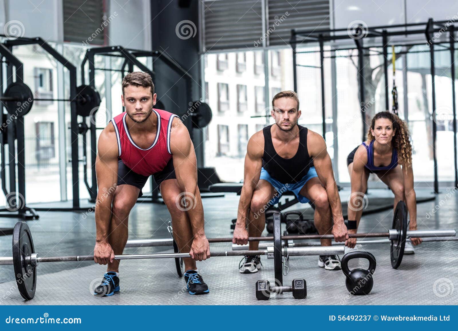Three Muscular Athletes Lifting a Barbell Stock Image - Image of ...