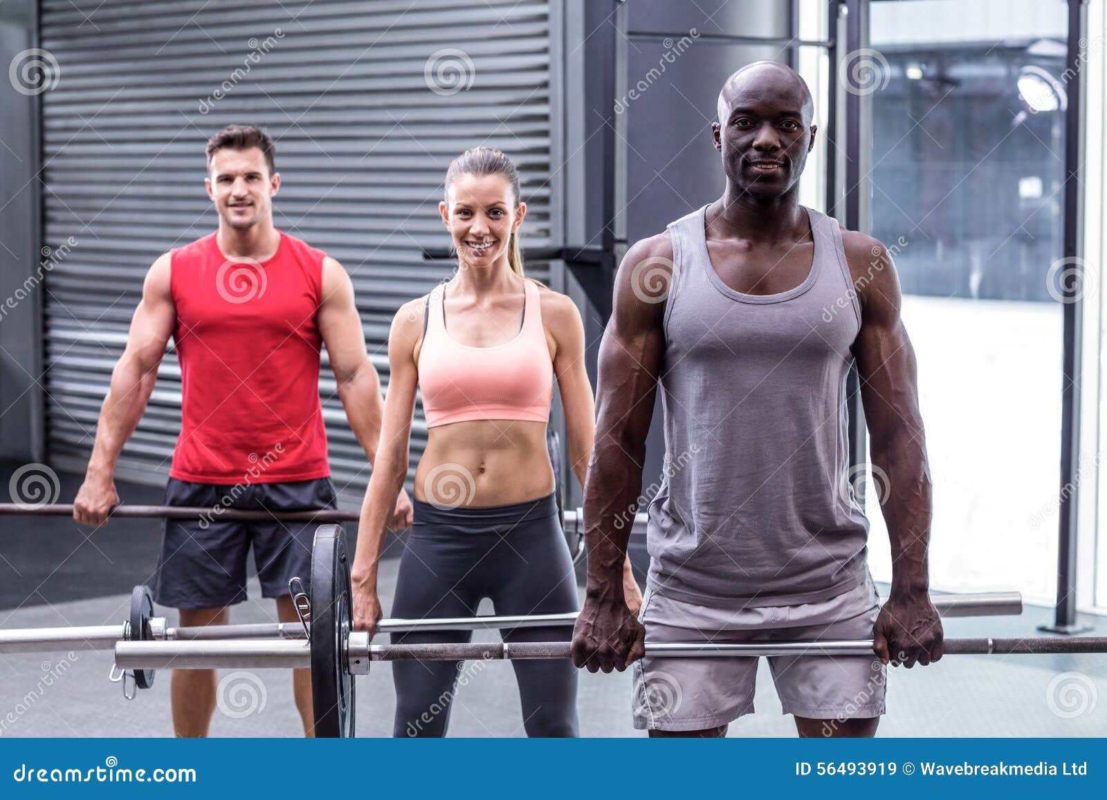 Three Muscular Athletes Lifting Barbells Stock Image - Image of ...