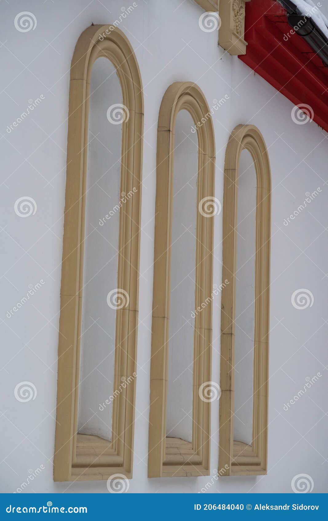 Three Narrow Arched Windows with Stone Trims on a White Plastered Wall ...