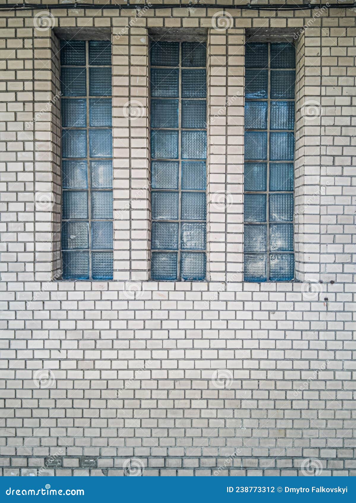 Three Narrow Windows on the Wall of an Old Building Lined with Ceramic ...