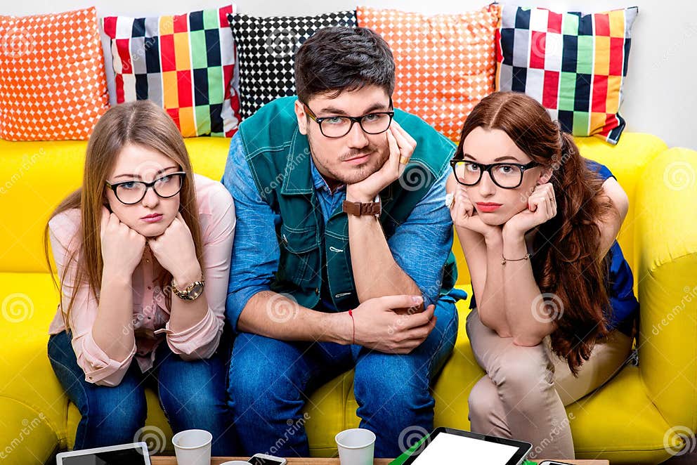 Three nerds on the couch stock photo. Image of beautiful - 49407734
