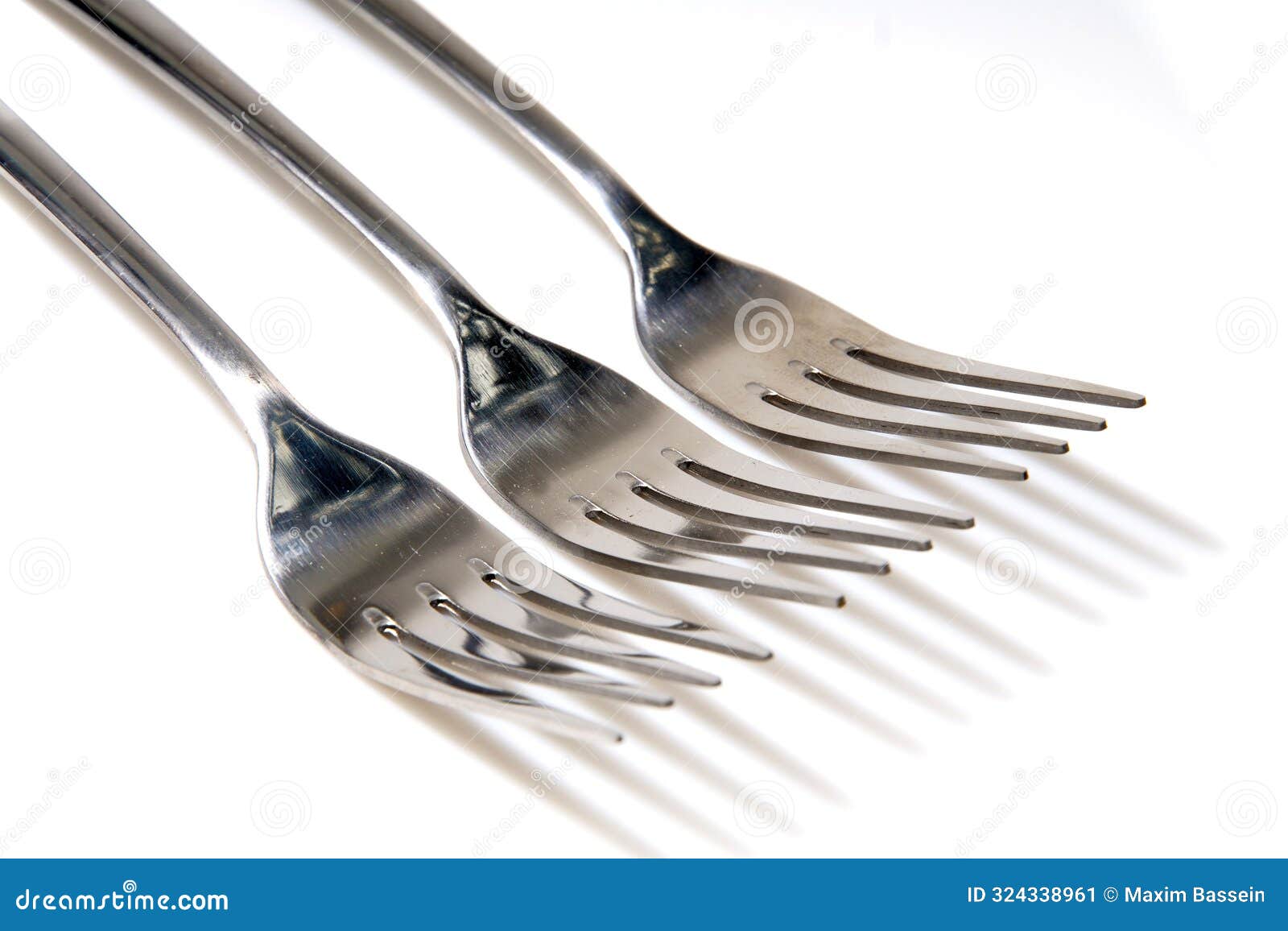 Three New Metal Forks with a Shadow on a White Background. Shooting ...
