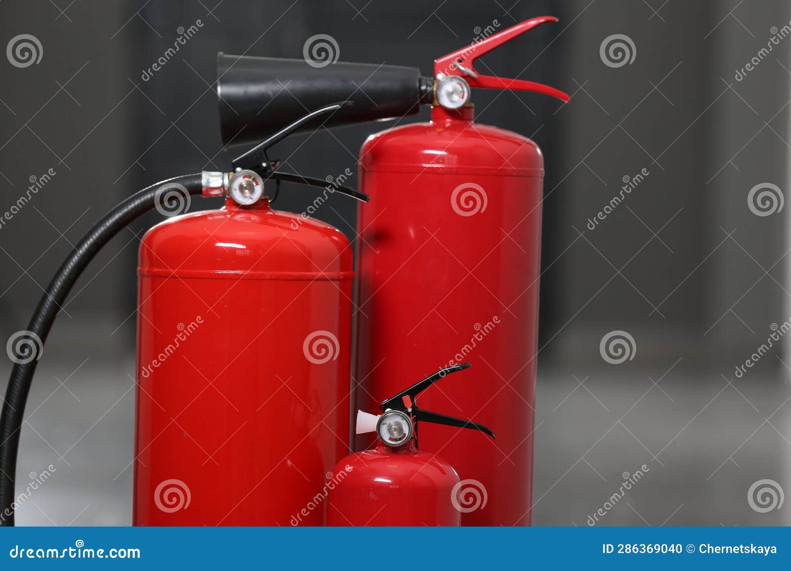 Three New Red Fire Extinguishers in Hall, Closeup. Space for Text Stock ...