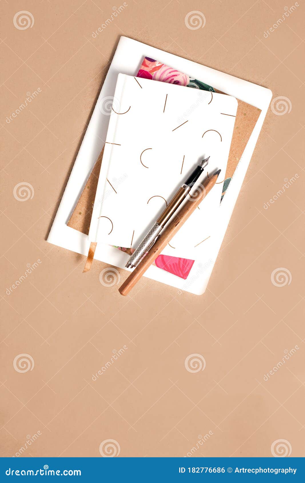 Three Notebooks on Golden Brown Background with Ink Pen and Copy Spaces ...