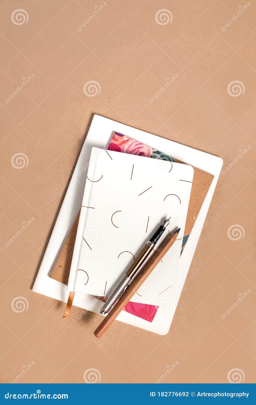 Three Notebooks on Golden Brown Background with Ink Pen and Copy Spaces ...