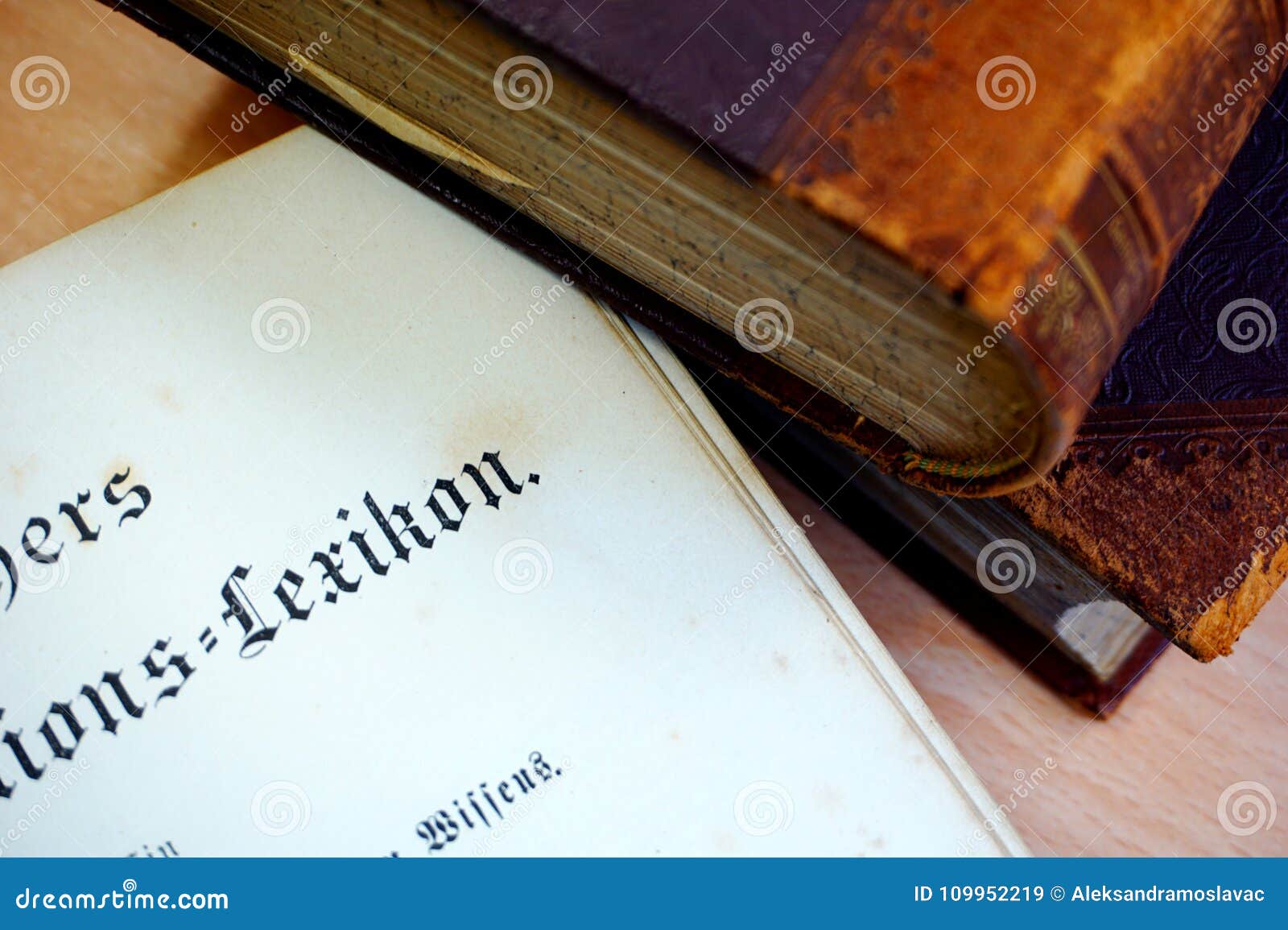 Three Old Books on the Table and Open Front Page of the Old Lexicon ...