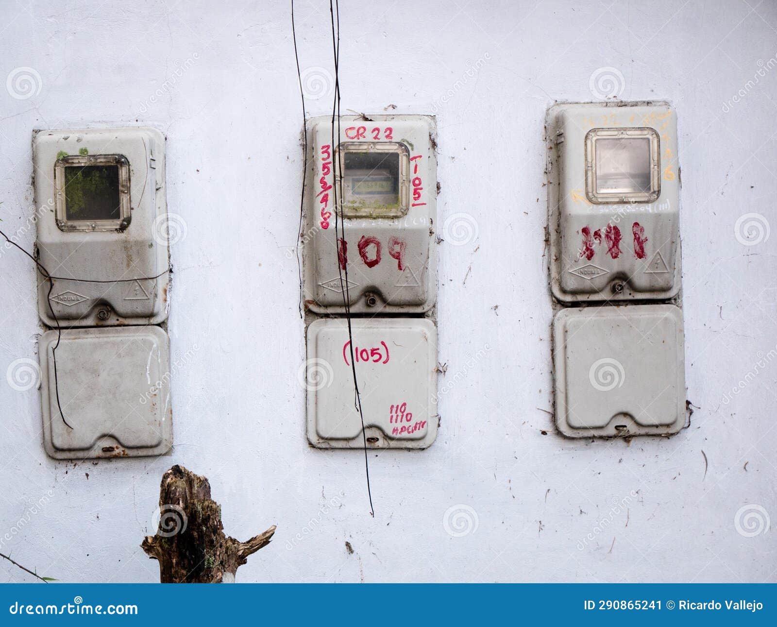 Three Old Electrical Meters Installed on a White Wall Stock Image ...