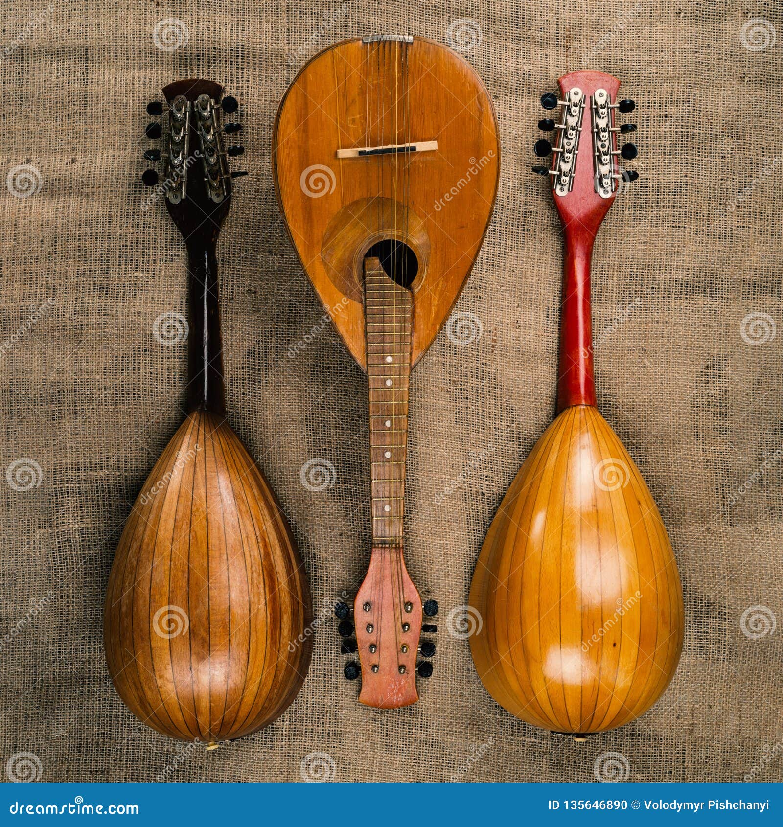 Three Old Mandolins On A Background Of Rough Burlap Texture. Royalty ...