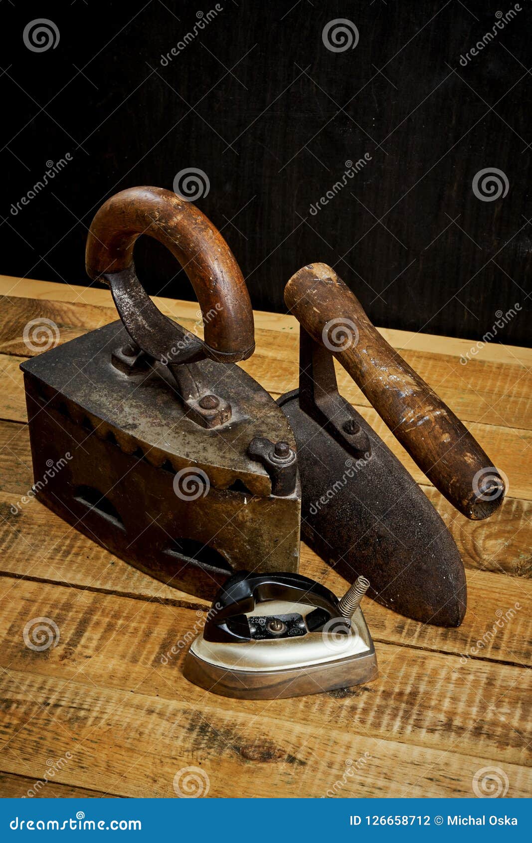 Three Old Rusty Iron on a Bright Wooden Table Stock Photo - Image of ...