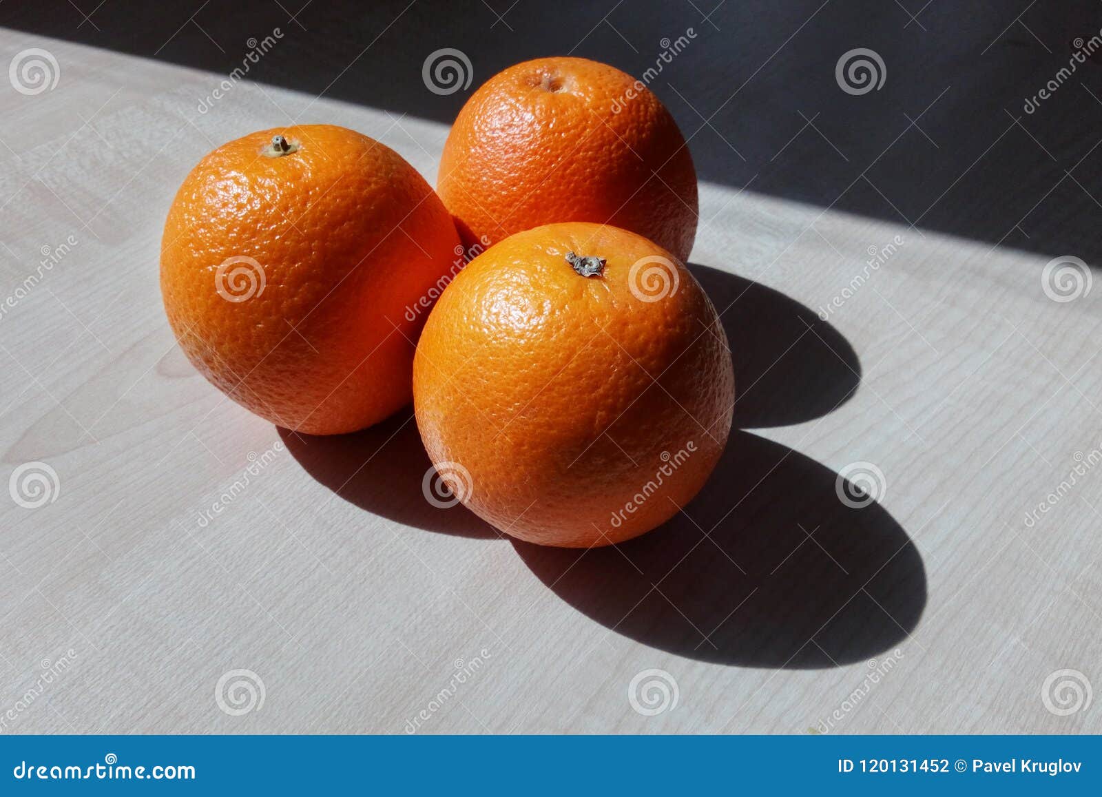 Three Oranges Lie on a Wooden Table in the Form of a Triangle Stock ...