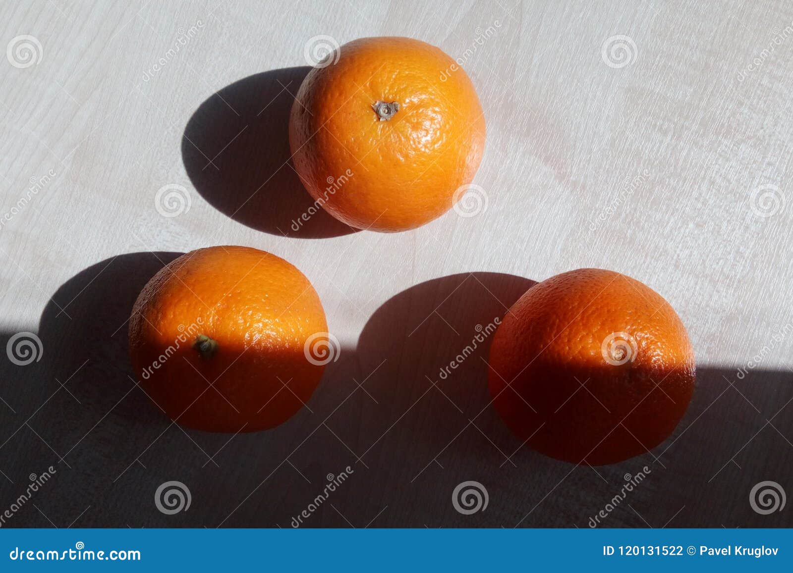 Three Oranges Lie on a Wooden Table in the Form of a Triangle Stock ...