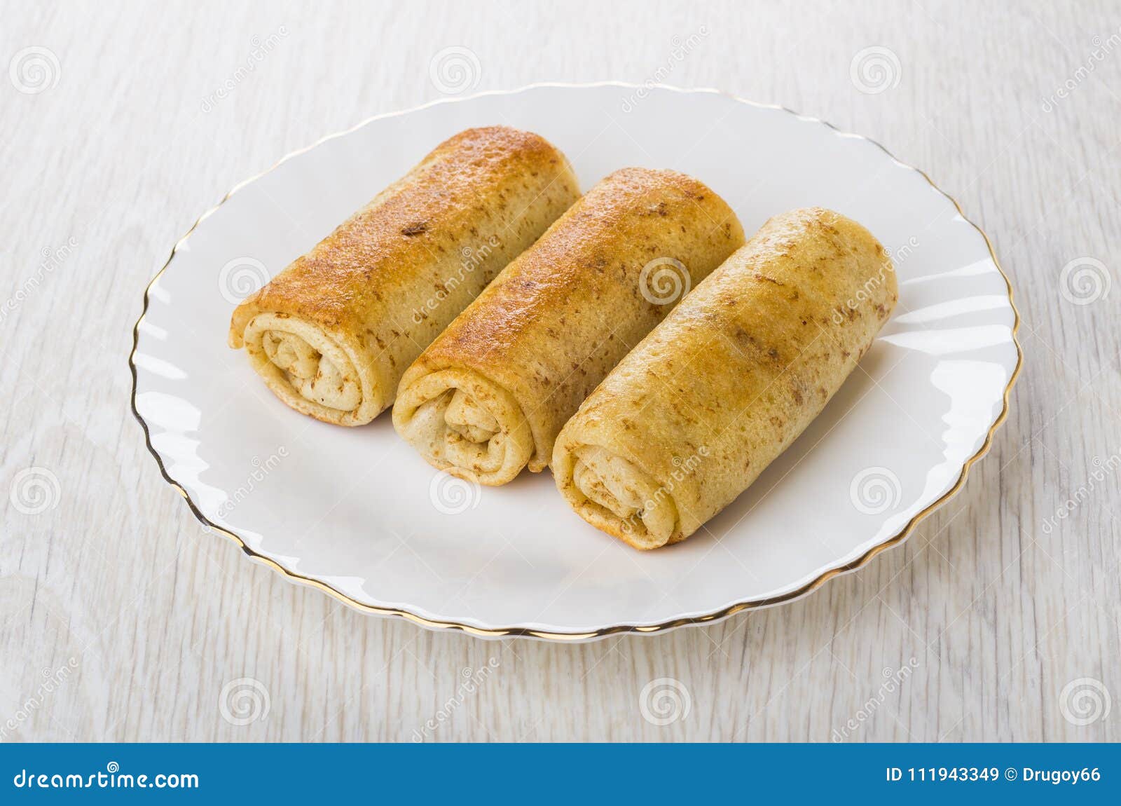 Three Pancake Rolls with Stuffed in White Plate on Table Stock Image ...