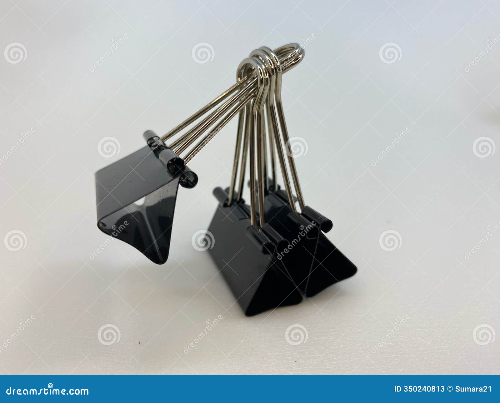 Three Paper Clips Shaped Like an Illustration of a Scale that is Biased ...