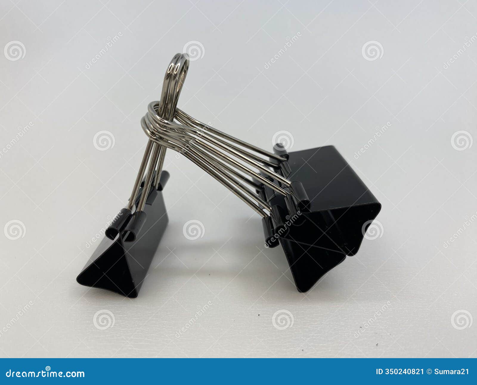 Three Paper Clips Shaped Like an Illustration of a Scale that is Biased ...