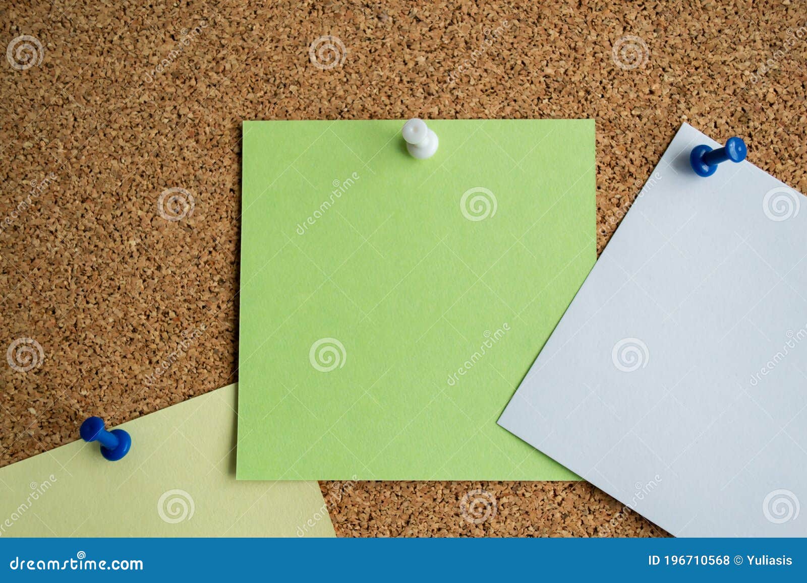Three Paper Notes Green, White and Yellow Color on a Cork Board ...