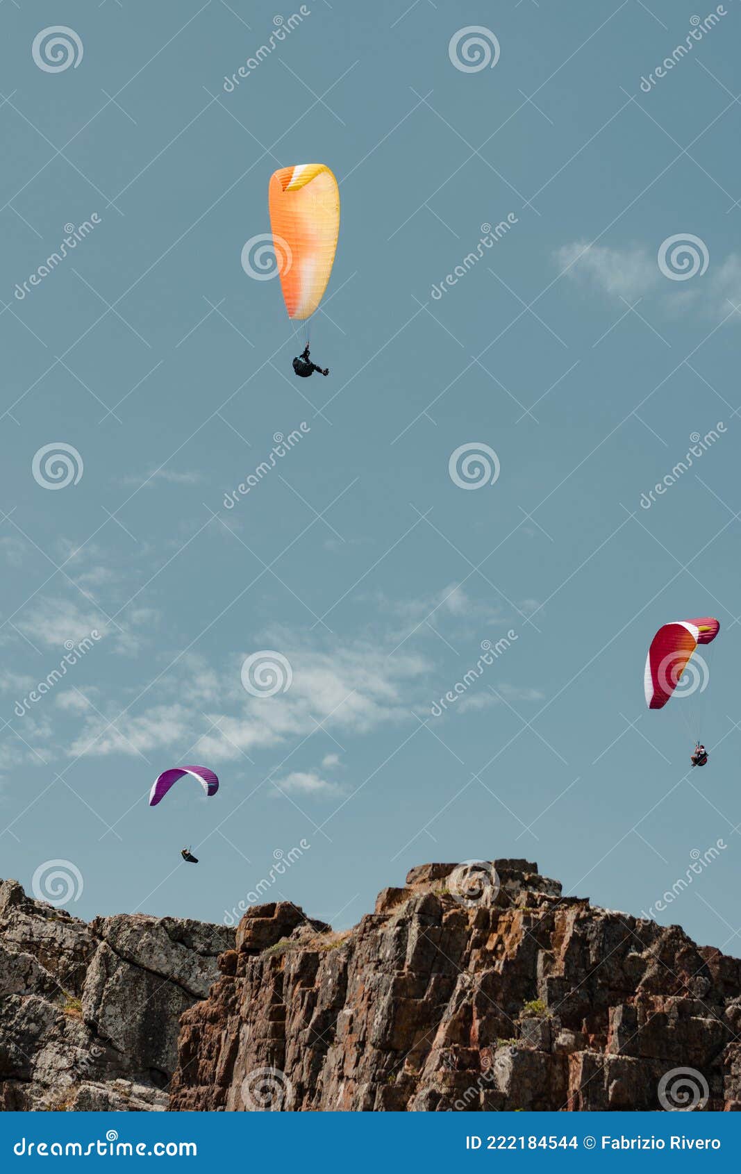 Three Paragliders Forming a Triangle while Gliding Over a Cliff Stock ...