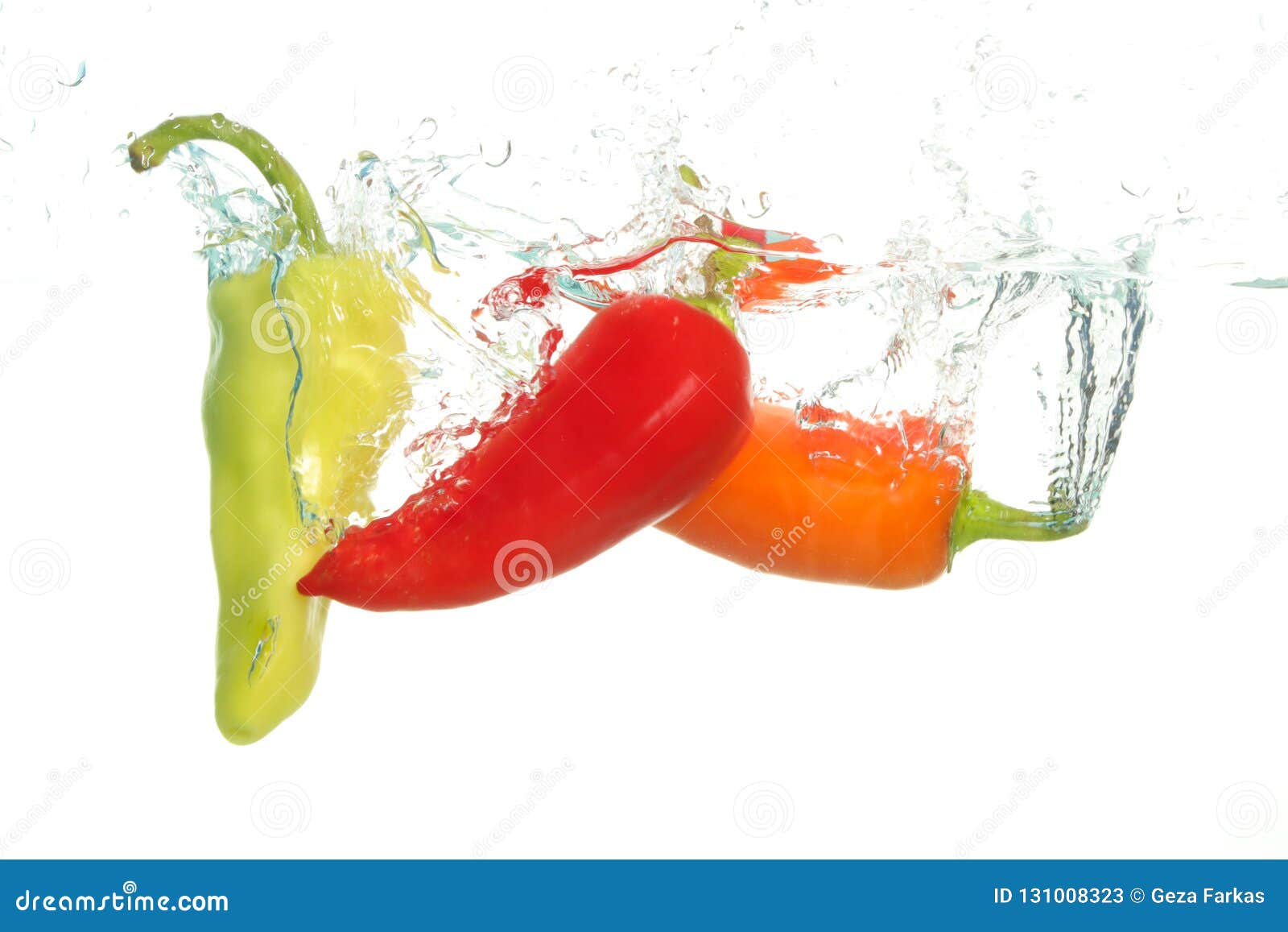 Three Peppers Red, Green and Orange in Water Splash on White Stock ...