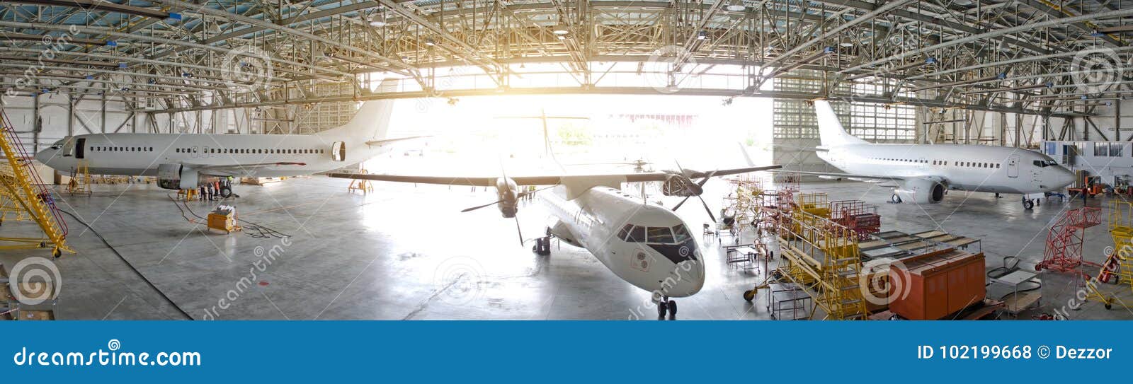 Three Passenger Aircraft in a Hangar with an Open Gate for Service ...