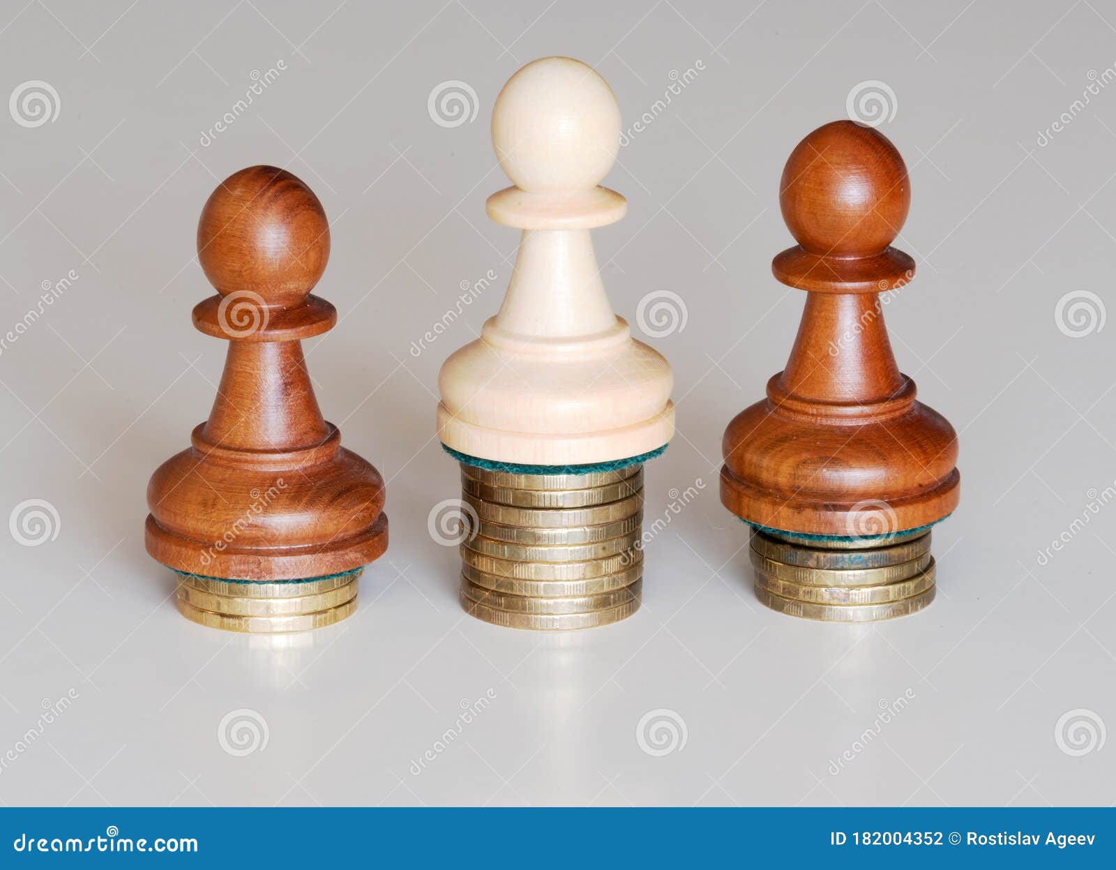 Three Pawns Chess Pieces on Columns of Coins, Symbolizing the ...