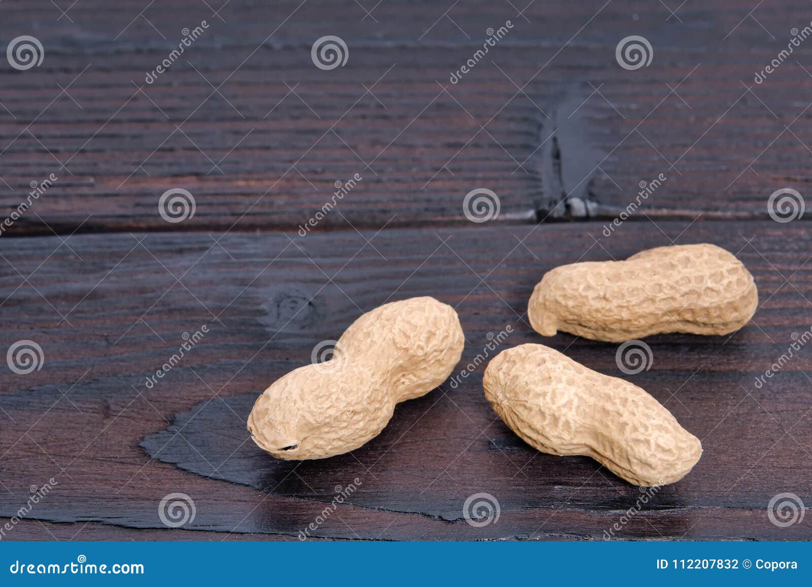 Three peanuts on a table stock photo. Image of health - 112207832
