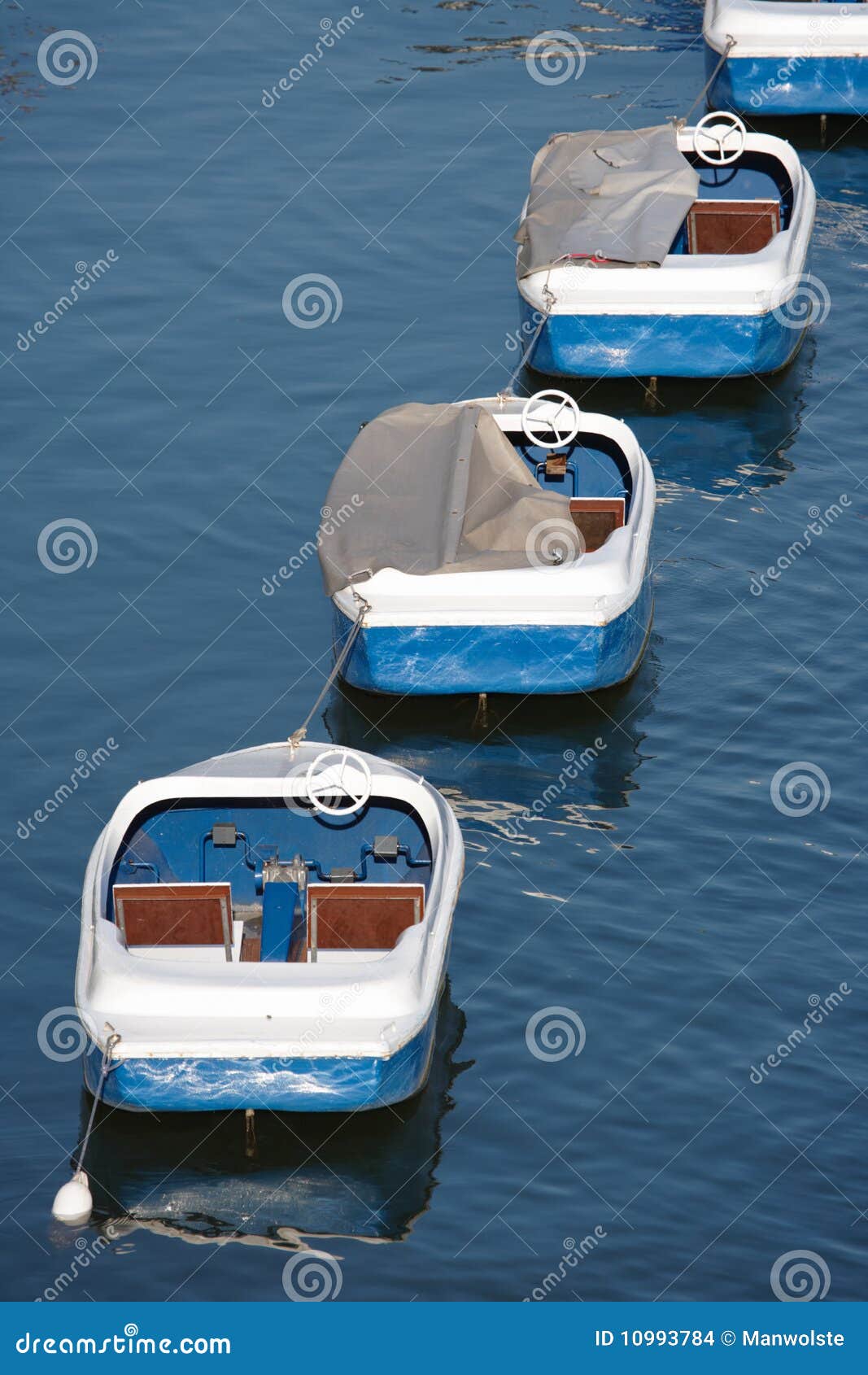 Three pedal boats in a row stock photo. Image of vacation - 10993784