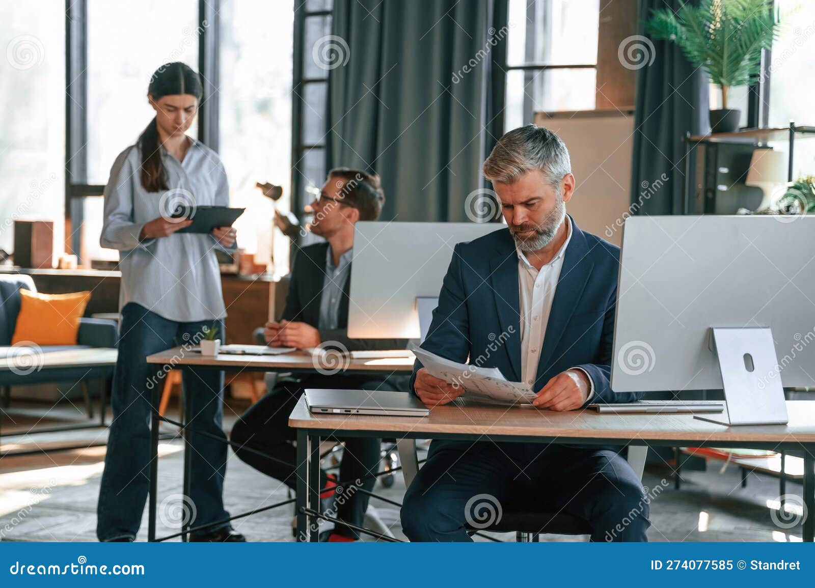 Three People are Busy in the Office. Group of Employees are Working ...